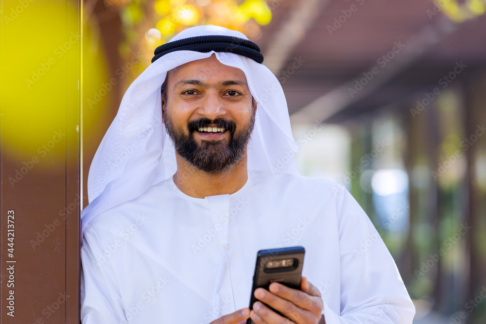 Middle Eastern Arab Emirati Vlogger holding mobile phone Stock Photo ...