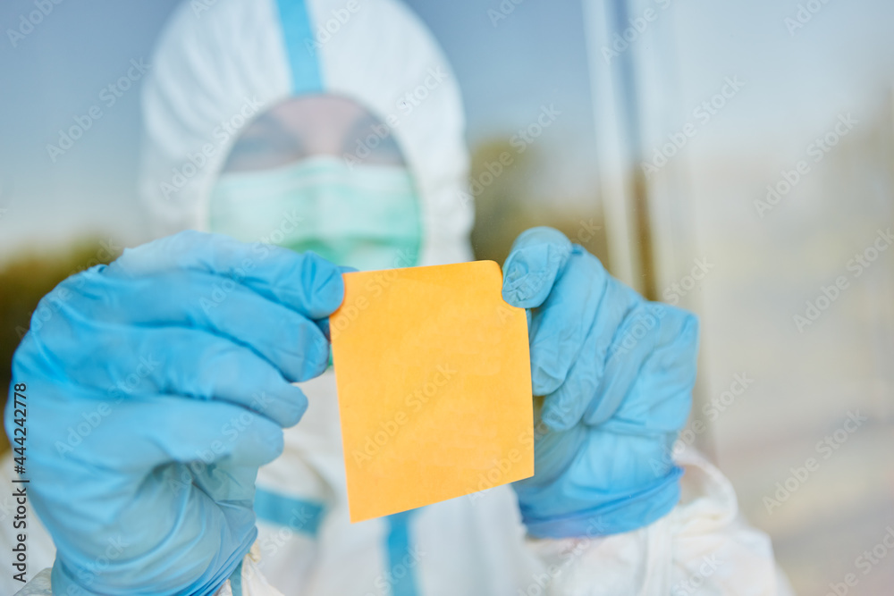 Yellow sticky note is attached to door or window of clinic with doctor ...