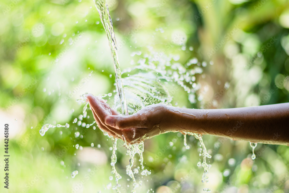 water pouring flow on woman hand on nature background Stock Photo ...