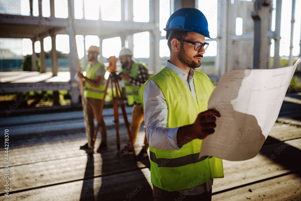 Architect and engineer construction workers working at outdoors ...