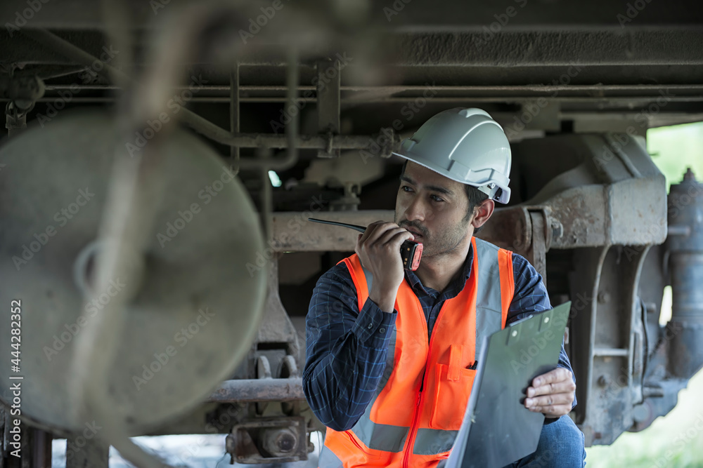 Foto de Railroad worker checking up wheels and braking system of ...