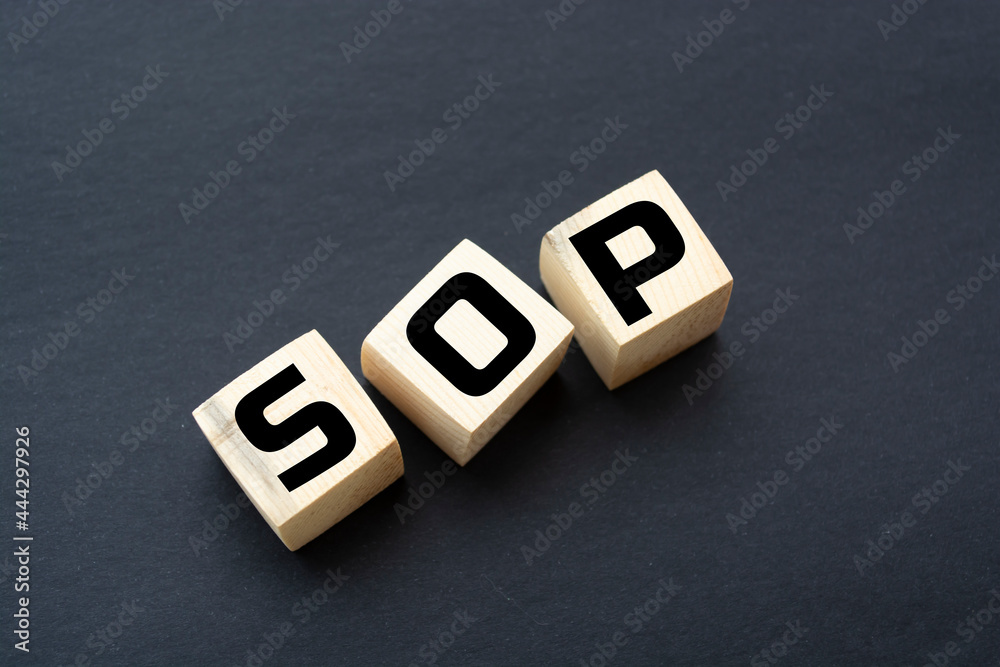 SOP - acronym from wooden blocks with letters, abbreviation SOP ...