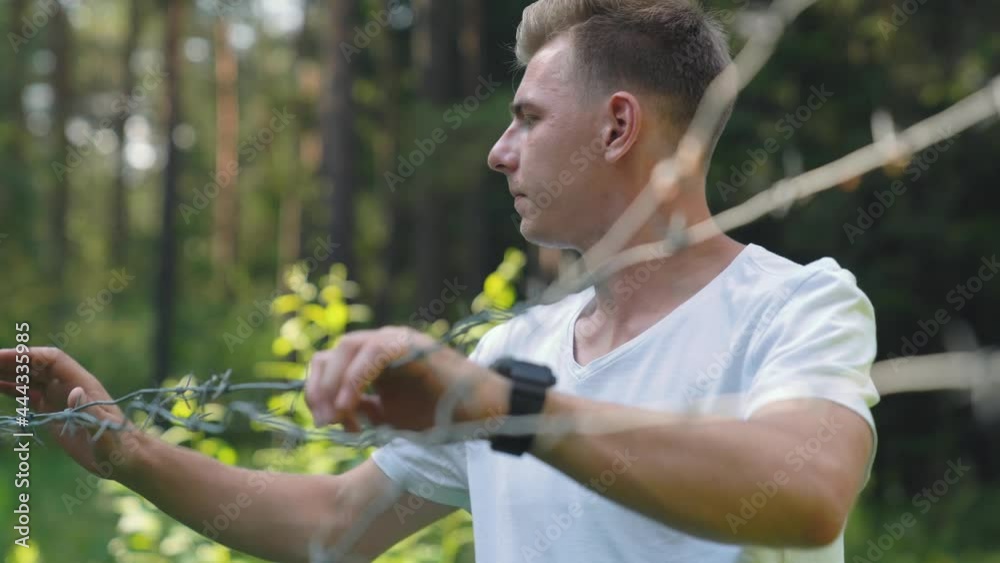 4K Shot of A frightened caucasian guy running through the forest ...