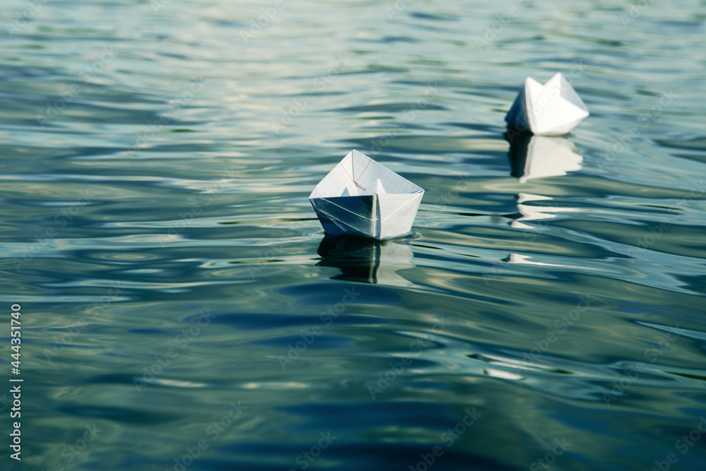paper boats made of a sheet of school notebook floating in water Stock ...