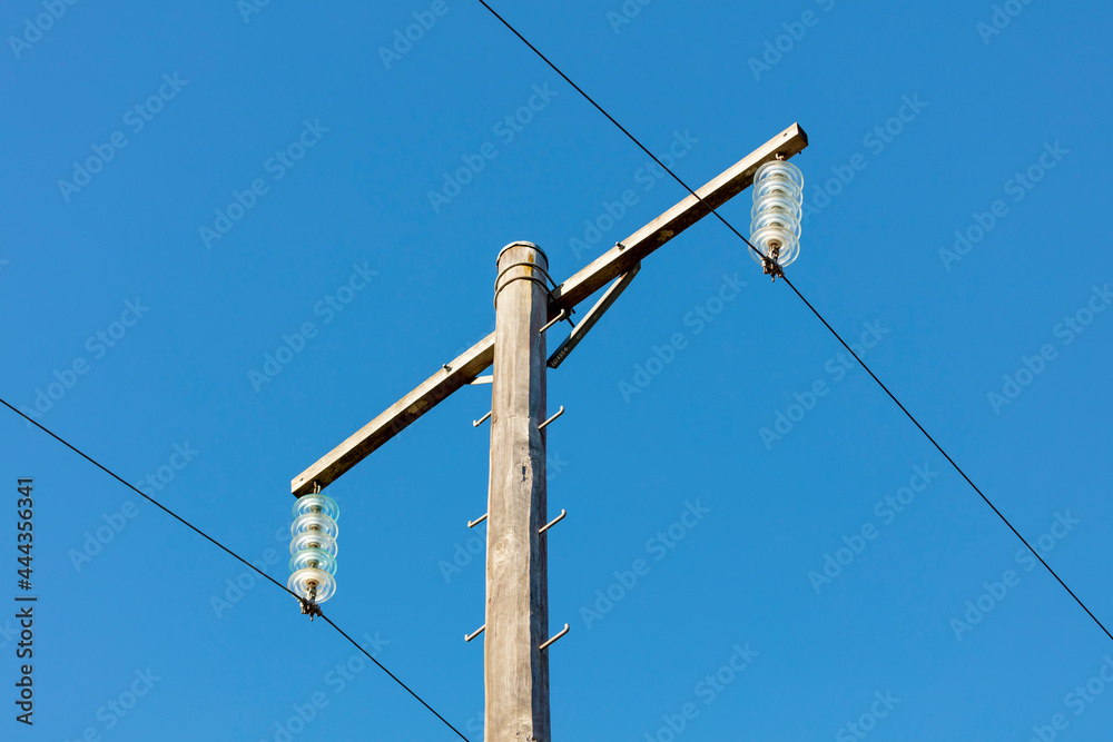 Photograph of a wooden telephone post and cables Stock Photo | Adobe Stock