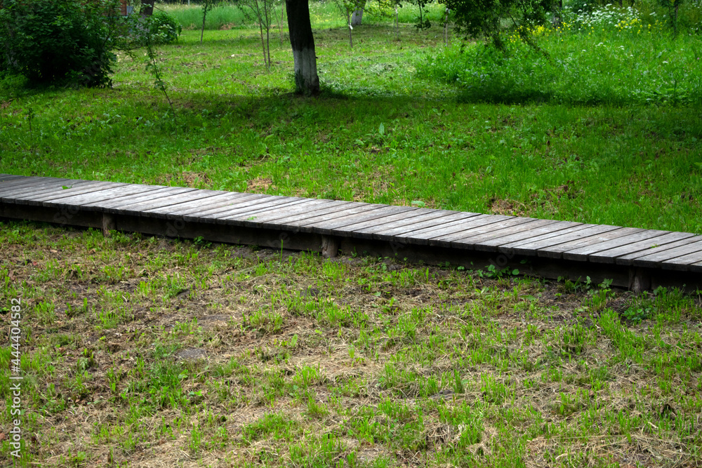 Wooden walkway. Sidewalk made of boards. The track in perspective ...