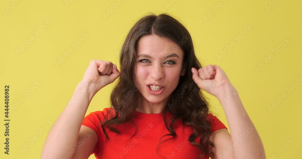 Happy woman screaming and dancing over yellow background Stock Video ...