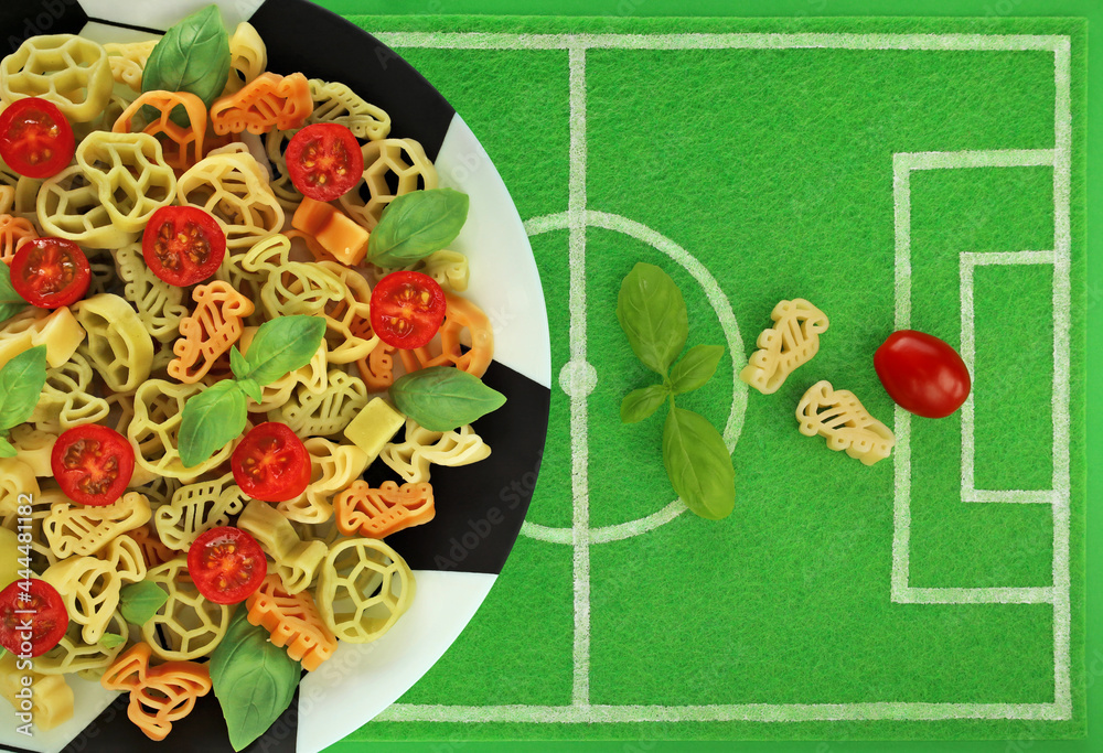 Tricolor pasta in form of football boots, balls and cups on plate like ...