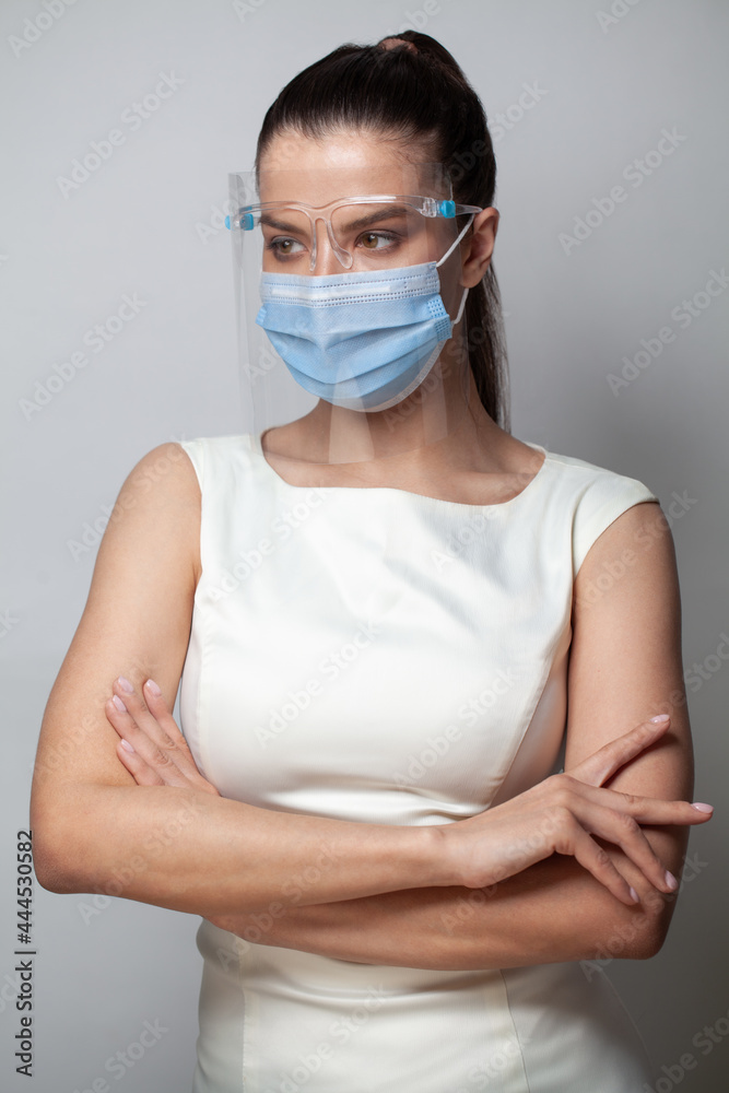 Female medical doctor wearing face shield and medical mask on white ...
