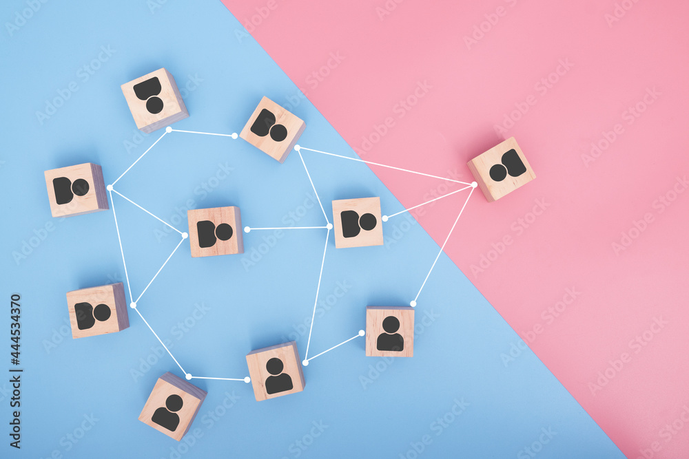 Wooden blocks connected together on pink and blue background. teamwork ...