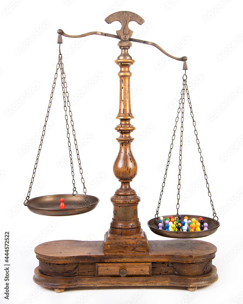 Scale with a wooden figurine on one side and many on the other, as a ...