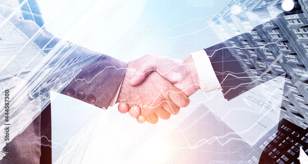 Double exposure of businessman handshake on stock market graph ...