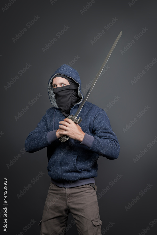 American Brutal man in a blue hoodie and black face mask with a fantasy ...