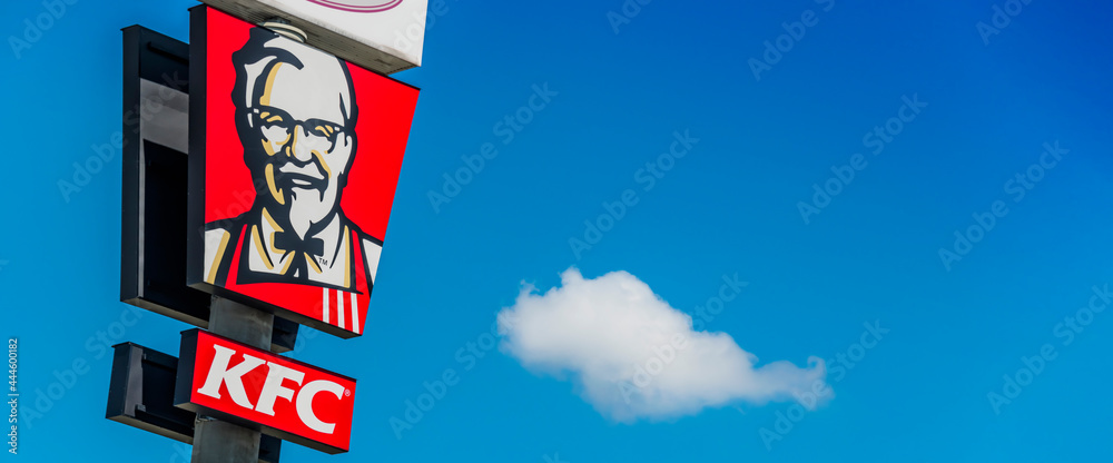 Kentucky Fried Chicken pylon sign over blue sky Stock Photo | Adobe Stock