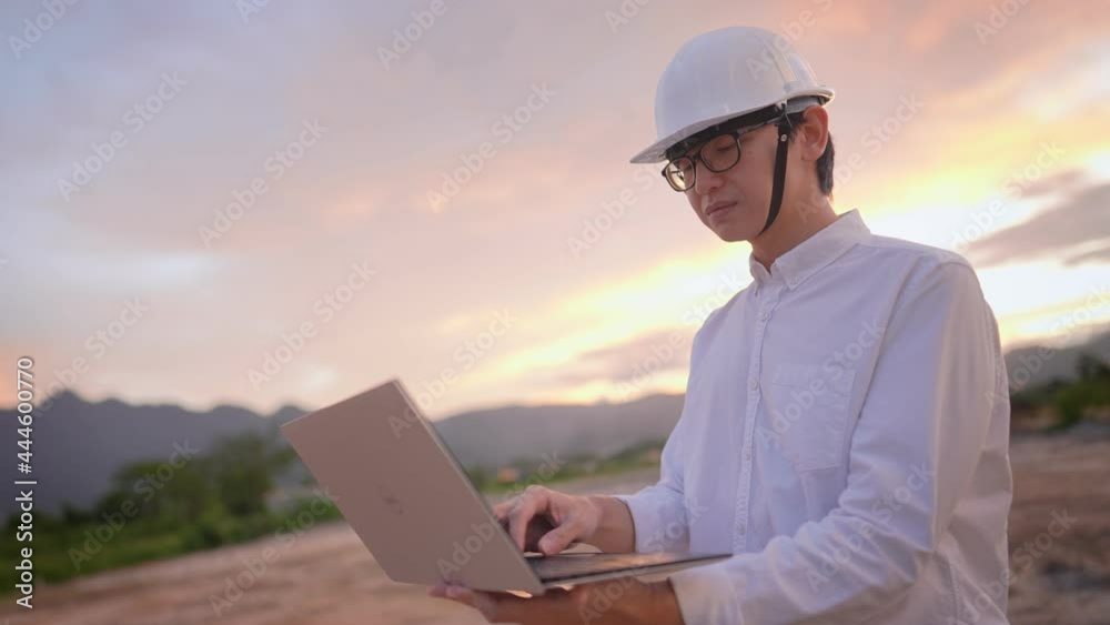 Young asian engineer wear glasses, safety helmet working with portable ...