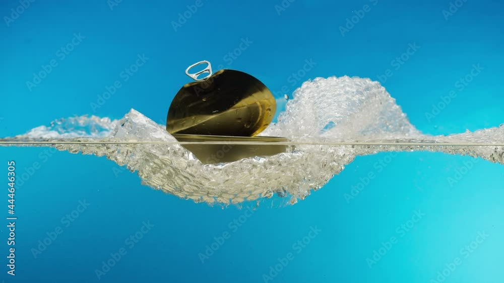 Floating metal tin can and food wrap in the ocean, garbage in the river ...