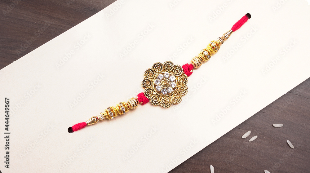 Indian festival: Raksha Bandhan background with an elegant Rakhi, Rice ...