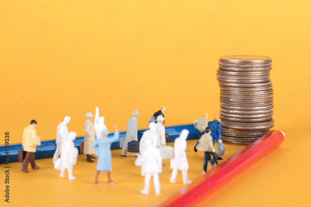 A large group of people running towards a miniature scene of a stack of ...