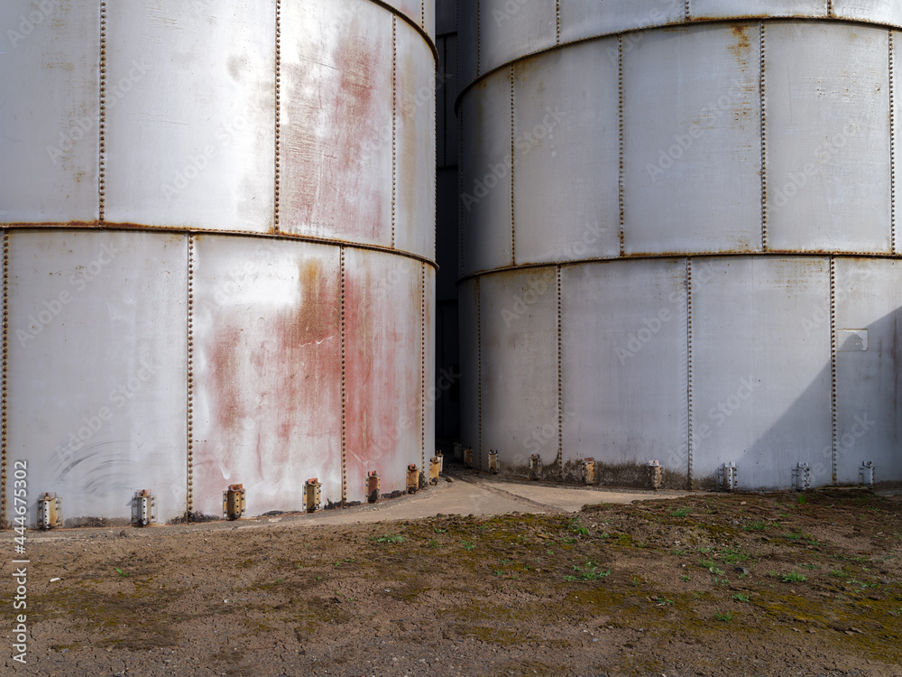 The bases of metal grain bins at a grain elevator in southeastern ...