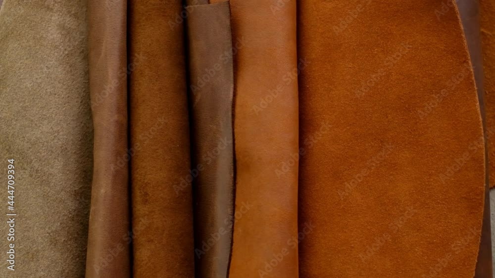 Genuine leather in warm brown tones. Rolls of genuine leather. Fabric ...