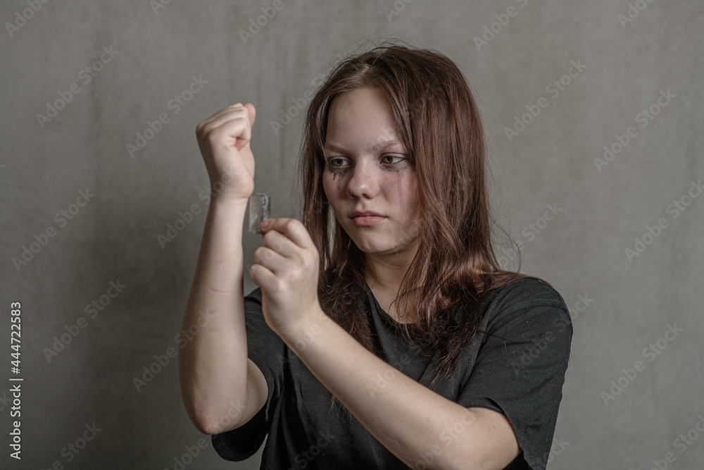 Teen girl trying cut veins on a her hand. Suicide concept Stock Photo ...
