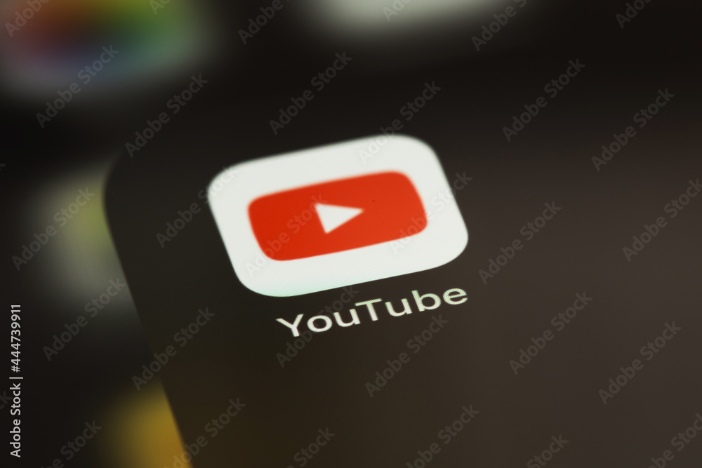 YouTube mobile icon app on screen smartphone iPhone closeup. YouTube is ...