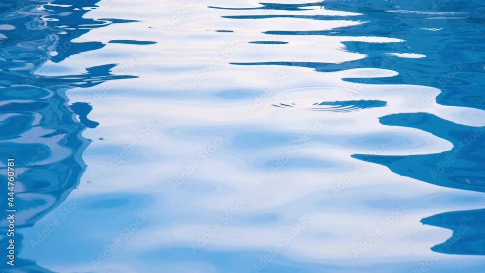 Calm Pure transparent blue water in the swimming pool with light ...