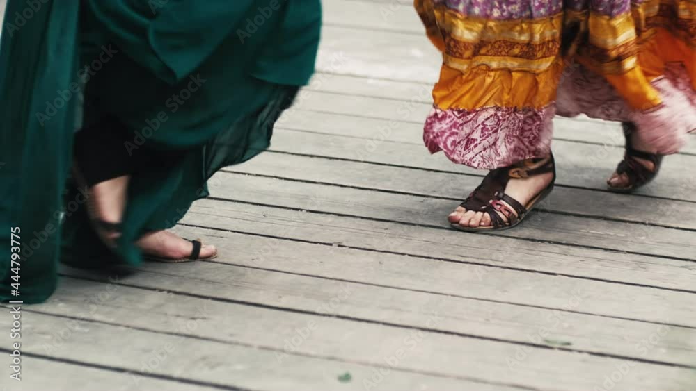 Two woman dancers in traditional dress dance opposite each other ...