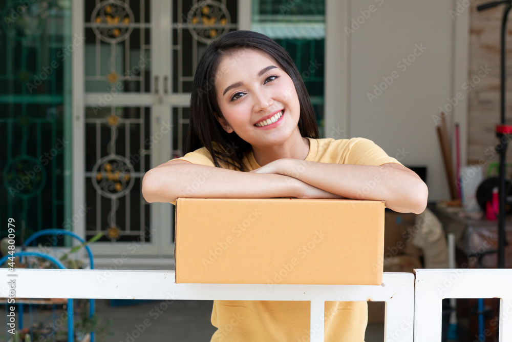 Asian woman receiving package from delivery service. Young Asian cute ...