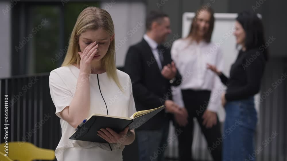 Stressed sad beautiful young woman crying standing outdoors with ...