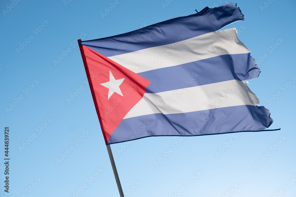 Cuban flag waving in wind. Flag of Cuba on blue sky background. Empty ...