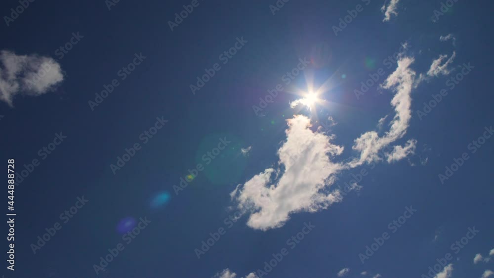 Close up of star shaped sun with blue sunny sky background and white ...