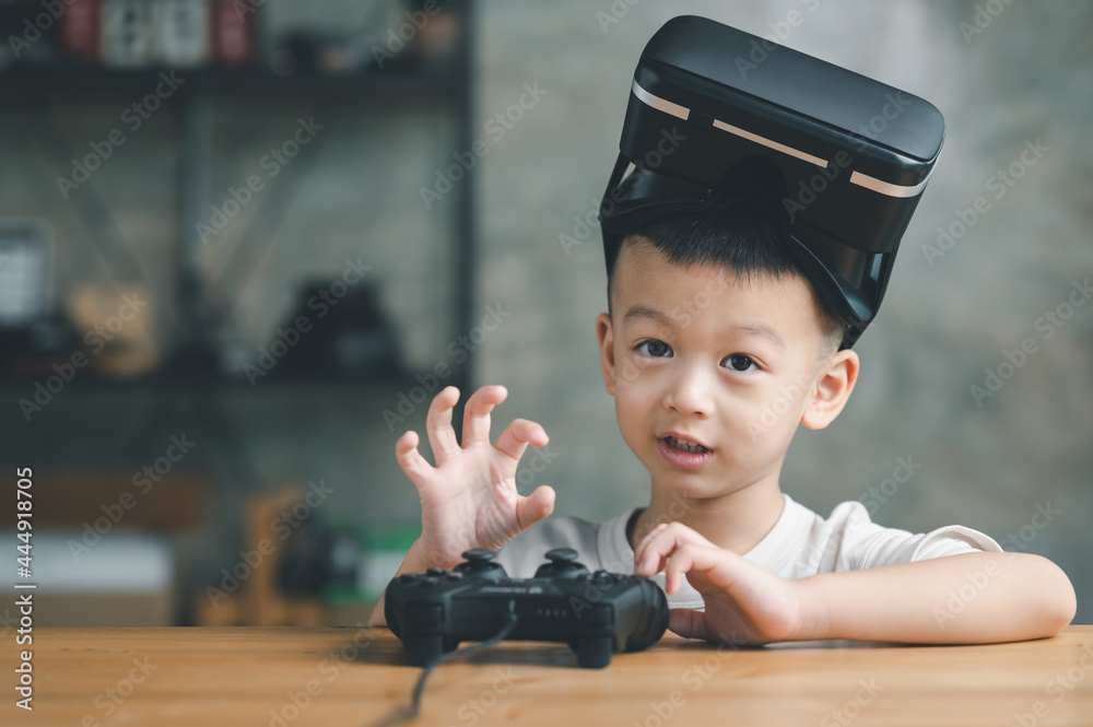 Asian boy kid child play virtual reality game wear VR glasses and ...