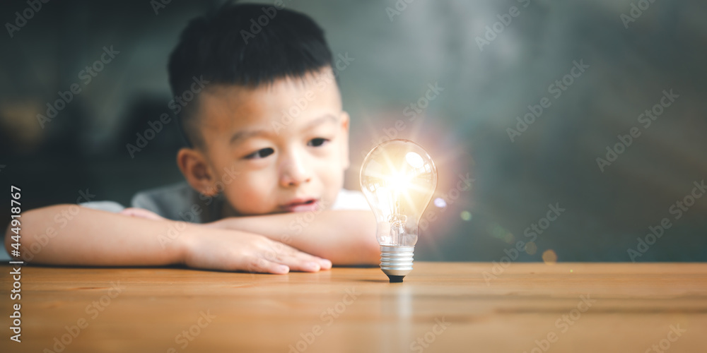 Boy kid Child with a bright light bulb. Concept of Ideas for presenting ...