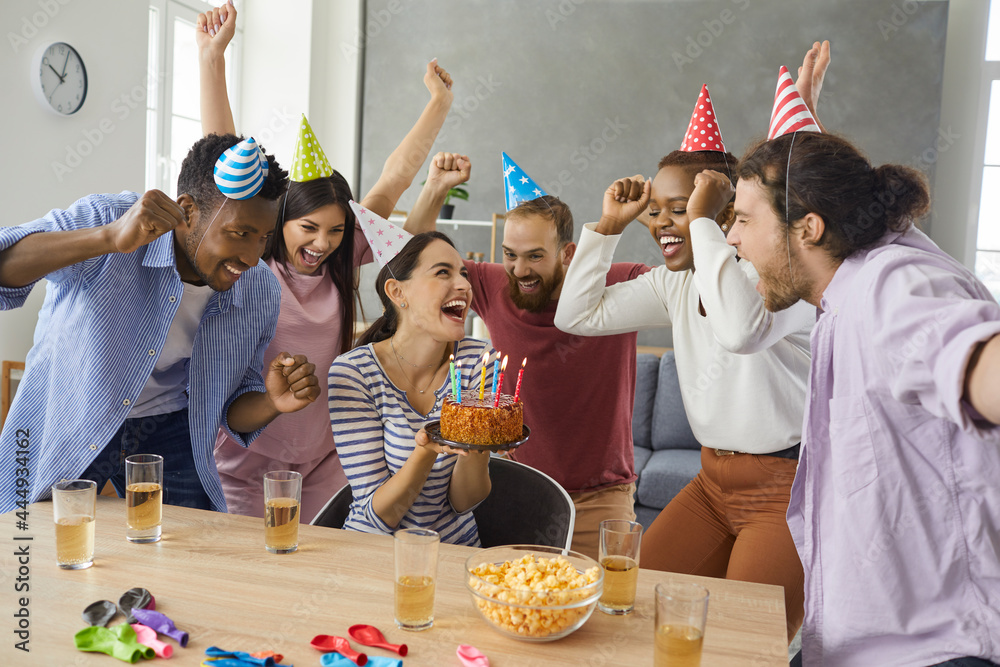 Multinational friends are celebrating a birthday at a friend's house ...