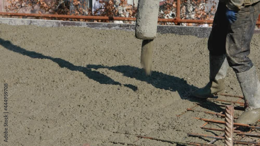 Engineers Pouring Concrete reinforcement into a floor metallic ...