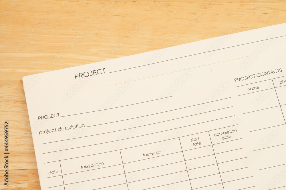 Manila project plan folder on a wood desk Stock Photo | Adobe Stock