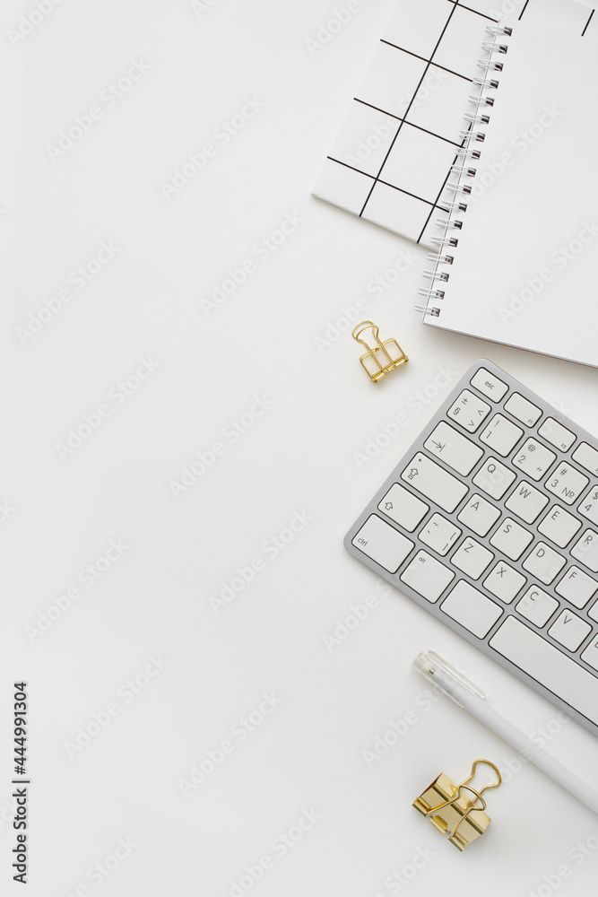 Notepad, keyboard, notebook, pen, golden binder paper clip on white ...