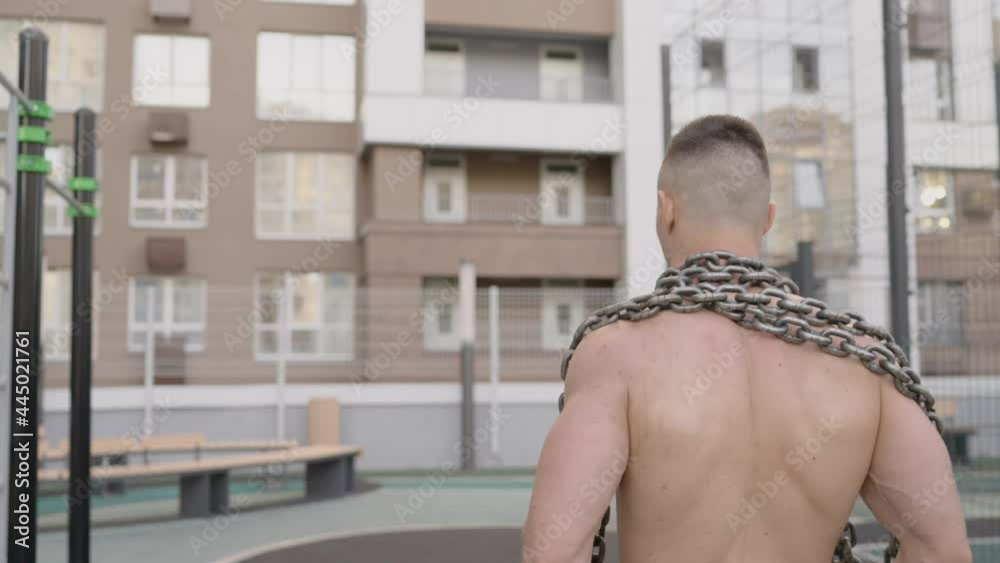 Athlete and training chain. Fight for fitness. Fit man with metal chain ...