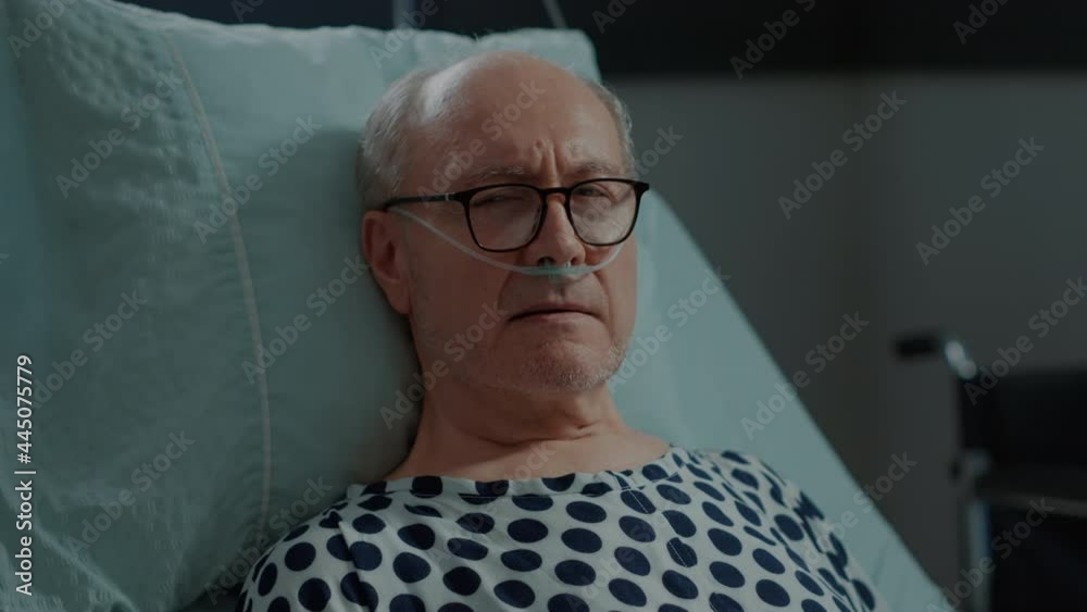 Portrait of ill patient laying in hospital ward at recovery unit with ...