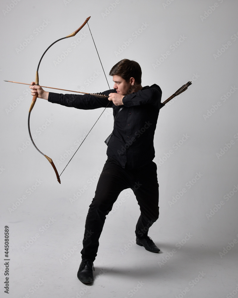 Full length portrait of a brunette man wearing black shirt and ...