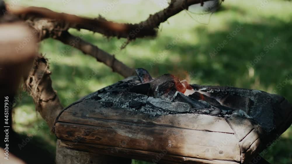 Ancient craft of blacksmithing. Blacksmith lights fire with help of ...