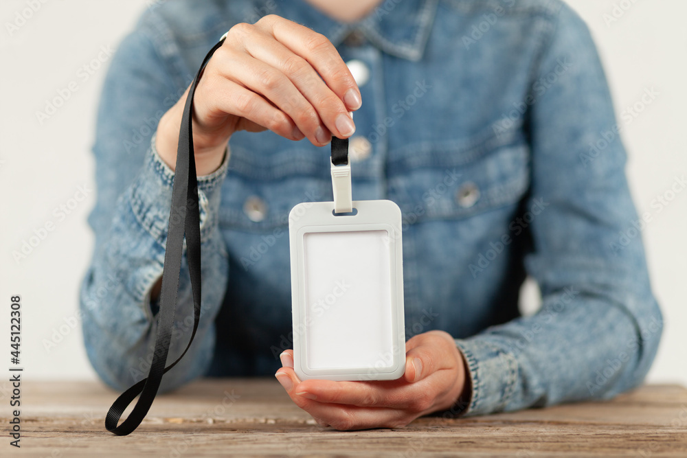 Empty identity badge in hands. Name tag template, security card mockup ...