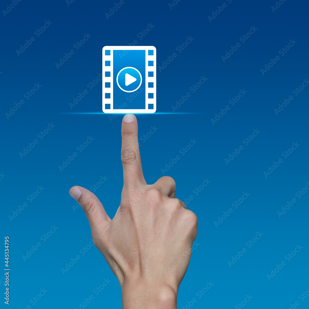 Hand pressing play button with movie flat icon over light blue gradient ...