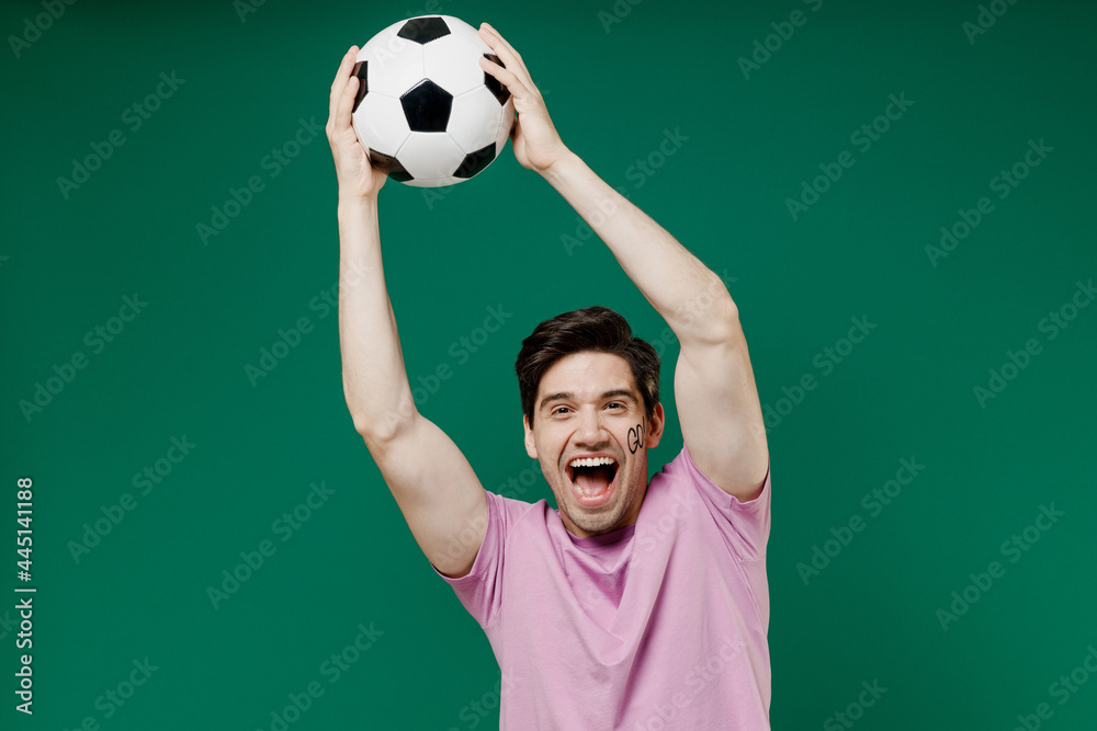 Young european man fan supporter wear basic pink t-shirt cheer up ...