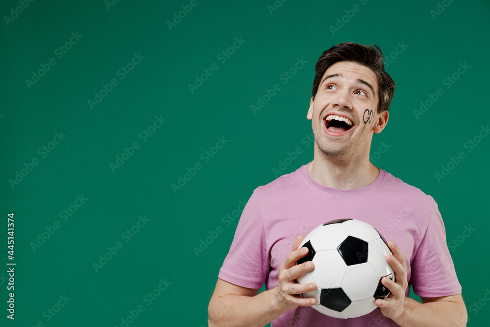 Young fun man fan wears basic pink t-shirt cheer up support football ...