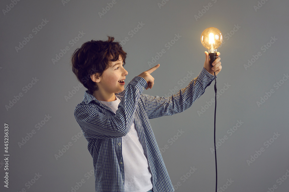 Foto de Little happy boy looks with admiration and points his finger at ...