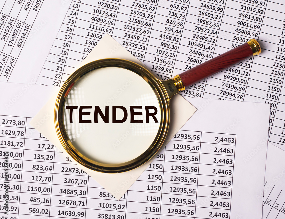 Word Tender through magnifying glass on office papers with numbers ...