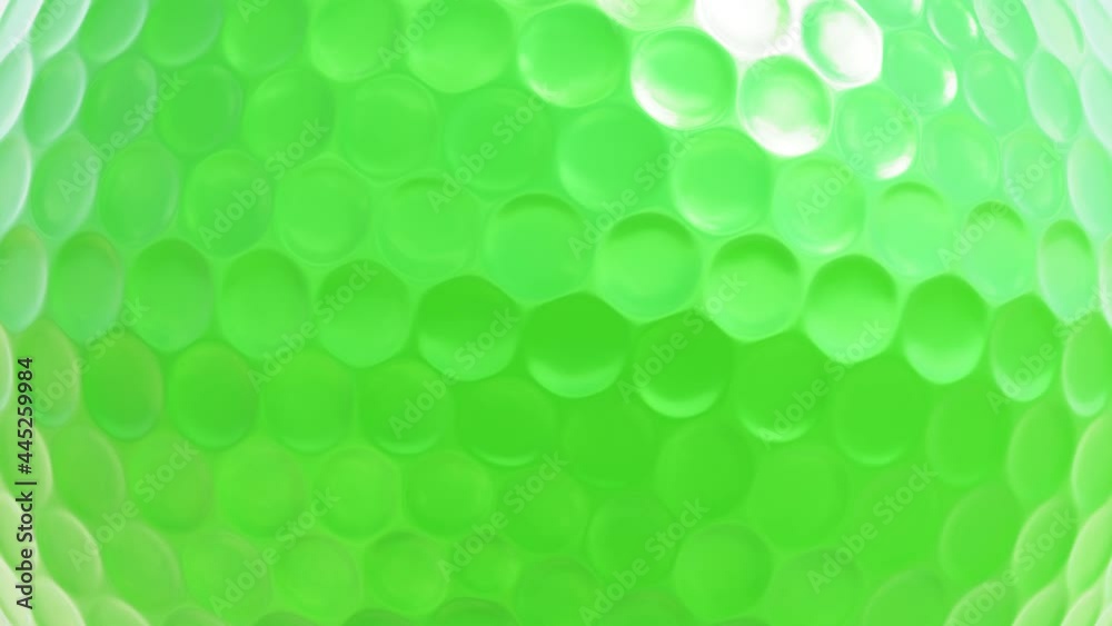 Realistic looping closeup view 3D animation of the spinning green golf ...