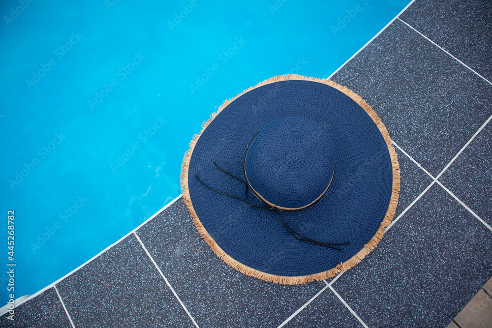 Straw hat on border of swimming pool, summer background Stock Photo ...